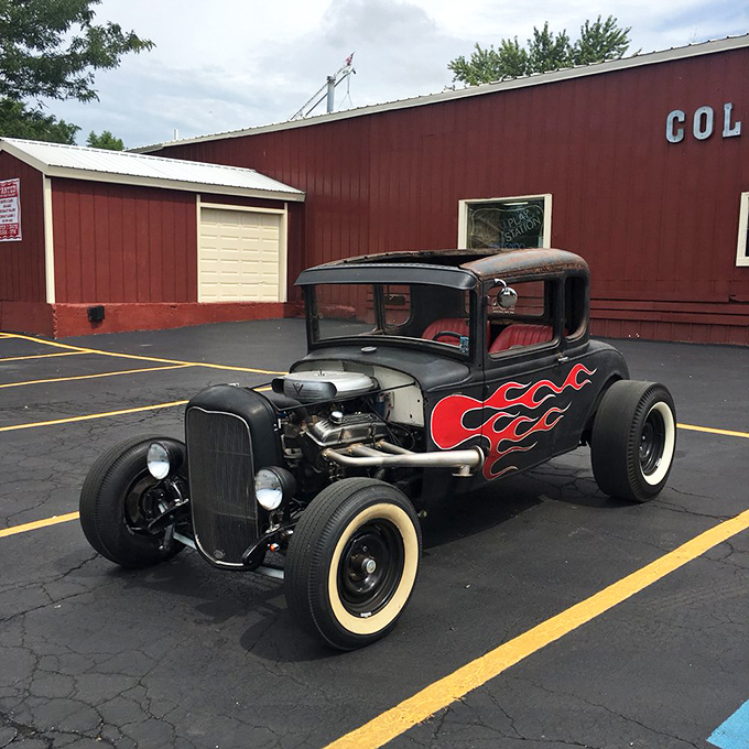Hot rod heaven! This flame-adorned vintage Ford sits proudly outside, reminding visitors that Volo's treasures extend beyond the barn walls.