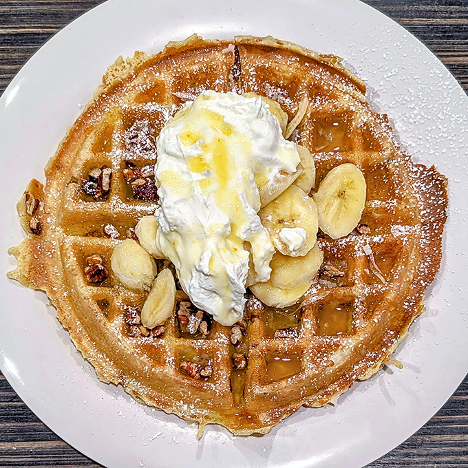 This banana-pecan waffle isn't just breakfast&mdash;it's therapy with maple syrup. The whipped cream is just showing off.