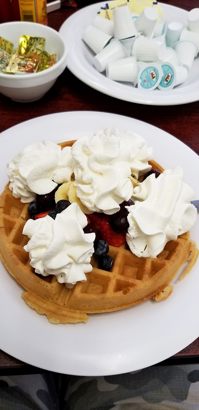 A waffle that's dressed for success with fresh berries and whipped cream clouds that practically demand a breakfast photoshoot.