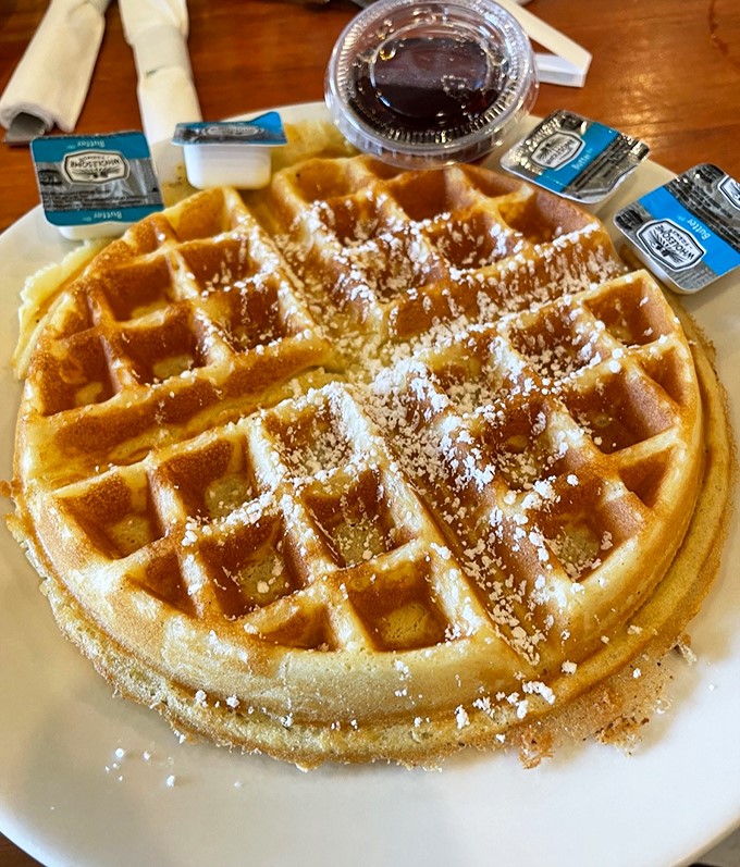 Belgian waffles with perfect grid precision&mdash;each square a tiny pool ready to collect butter and syrup in delicious harmony.