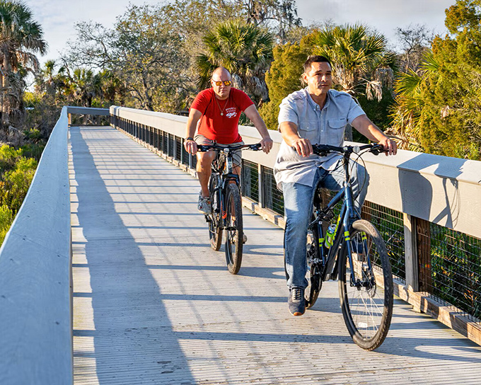 Two cyclists enjoying the boardwalk at Werner-Boyce Salt Springs State Park &ndash; nature's treadmill with infinitely better scenery.