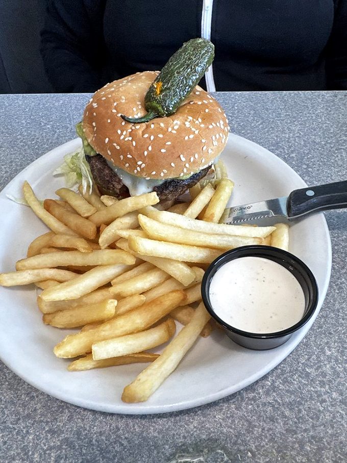 When a burger comes with a pickle standing at attention like that, you know someone in the kitchen cares. French fries as supporting actors.