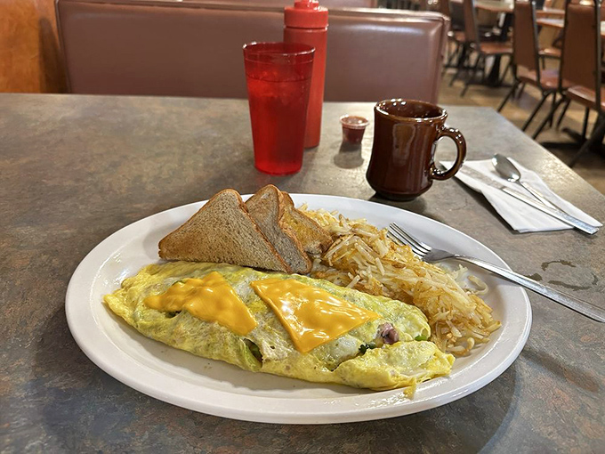 This Western omelette arrives fluffy and golden, packed with enough protein to fuel your entire morning adventure.