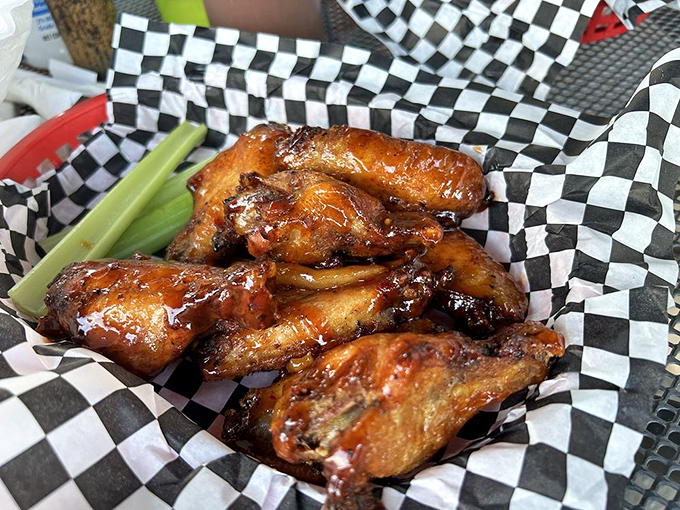 These wings glisten with sauce like they're auditioning for a food magazine cover shoot, their caramelized edges promising a perfect sweet-heat balance.