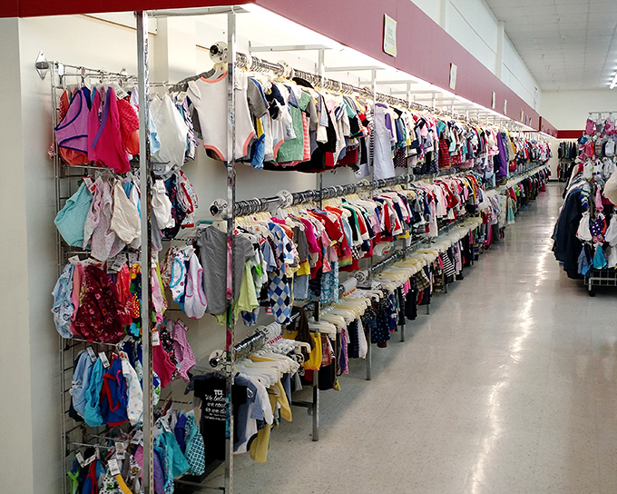 Tiny clothes for tiny humans, all meticulously organized—unlike the actual rooms of the children who'll wear them.