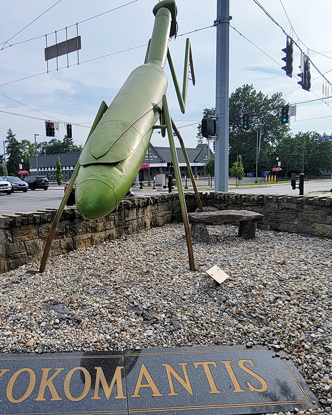 From behind, KokoMantis reveals its impressive engineering&mdash;seventeen feet of metal mantis balanced perfectly on stone, defying both gravity and convention.