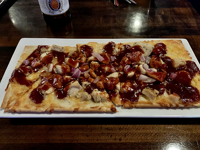 Flatbread topped with BBQ chicken, red onions, and cheese &ndash; comfort food elevated to an art form worth celebrating.