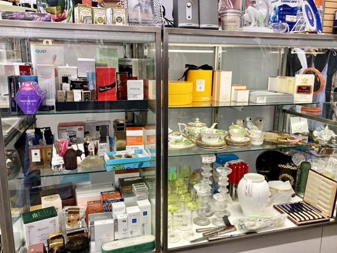 A glass case shrine to luxury beauty and collectibles&mdash;proof that someone's decluttering crisis has become your vanity's jackpot.