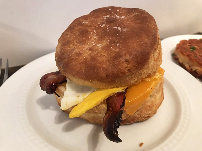 The breakfast sandwich that launched a thousand cravings—a perfect golden biscuit embracing eggs, cheese, and bacon with buttery abandon.