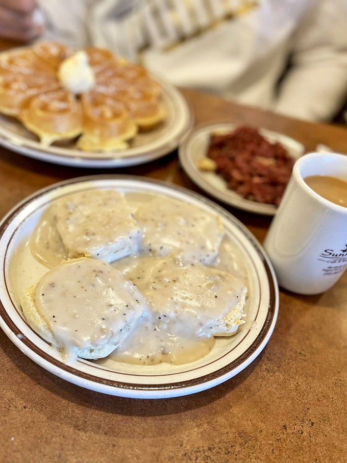 Biscuits drowning happily in creamy pepper gravy – Southern comfort food that makes you want to adopt a drawl and say "y'all" unironically.