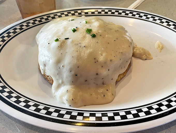 This isn't just biscuits and gravy &ndash; it's a Southern hug on a plate. That pepper-speckled cream sauce blankets everything in velvety comfort.