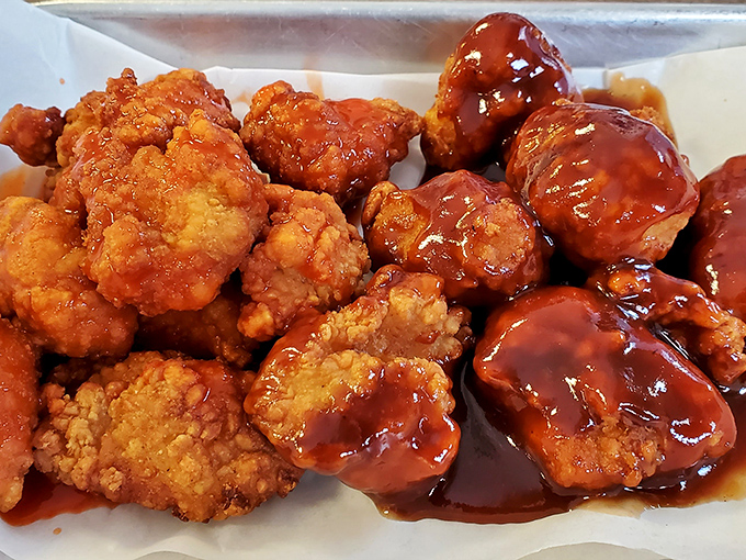 These boneless wings wear their sauce like a badge of honor, glistening with spicy perfection.