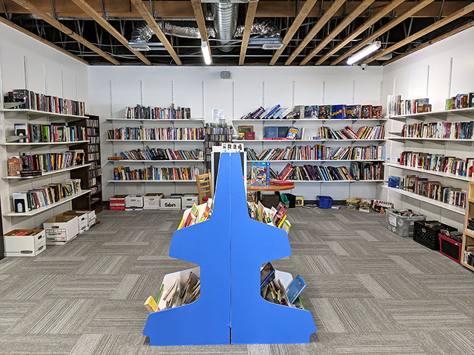 The book section rivals small libraries, with blue display stands creating islands of literary possibility in a sea of potential reads.
