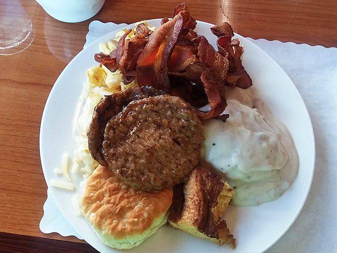 A breakfast plate that doesn't mess around &ndash; meat, eggs, gravy, and a biscuit standing at attention like delicious soldiers ready for duty.