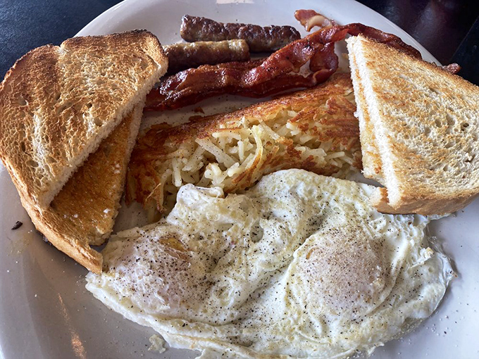 The breakfast trinity: perfectly crispy hash browns, eggs with just the right amount of jiggle, and bacon that would make a vegetarian question their life choices. 