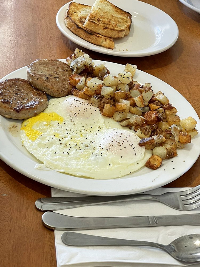 A breakfast plate that means business &ndash; eggs, sausage, and those golden potatoes that somehow taste like Sunday mornings.