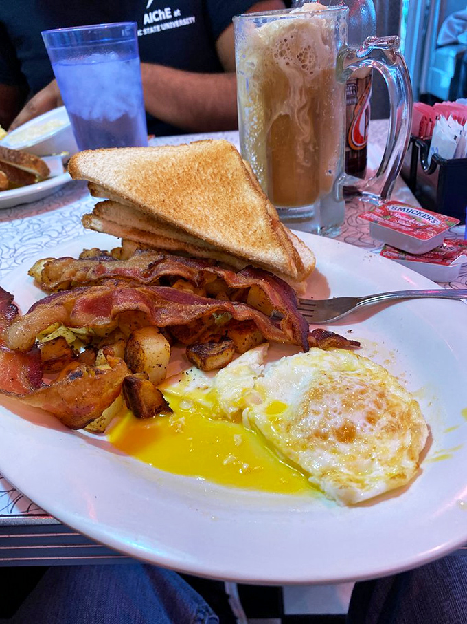 The breakfast platter that answers the eternal question: "Why choose?" Eggs, bacon, pancakes, and grits create a morning symphony.