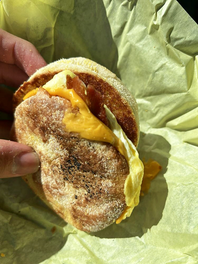 The breakfast sandwich&mdash;portable perfection between English muffin bookends. That melty cheese is performing gravity-defying feats worthy of a Vegas show.