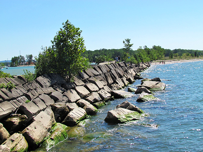 The breakwater's massive stone blocks create a perfect fishing perch and wave-watching spot. Engineering meets entertainment.