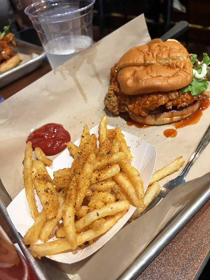 This fried chicken sandwich, dripping with sauce and perfectly crisp, makes you wonder if chickens secretly aspire to this level of deliciousness.
