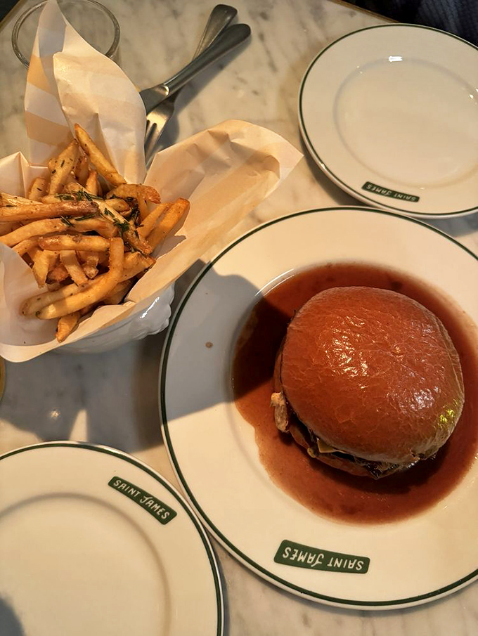 Some burgers need their own ZIP code. This one, swimming happily in its jus, has clearly found the perfect neighborhood.