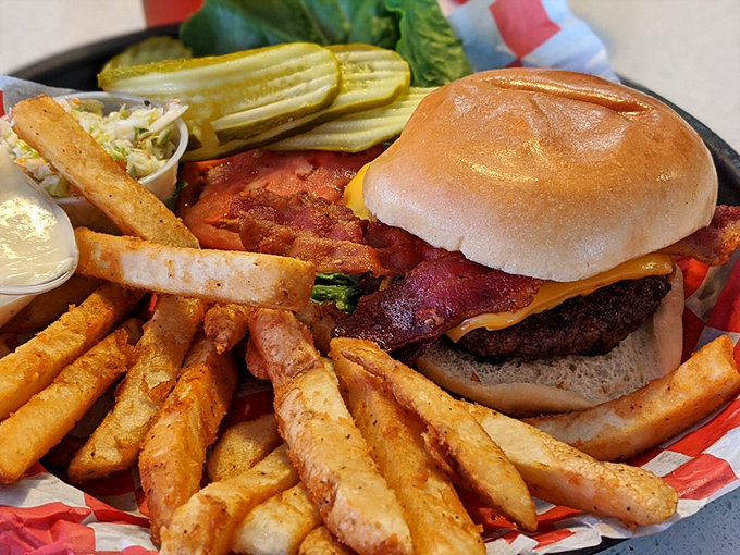 This isn't just a burger &ndash; it's architecture. A towering achievement of beef, bacon, and cheese flanked by crispy fry sentinels.
