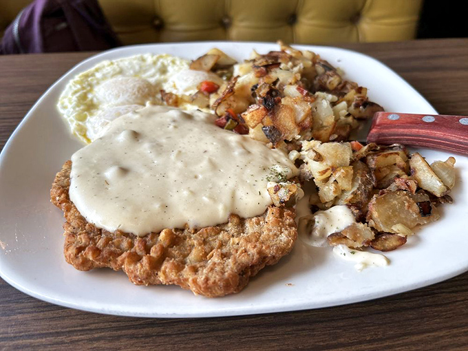 Chicken fried steak smothered in country gravy alongside eggs and those legendary potatoes &ndash; the breakfast trifecta that makes mornings worth facing.