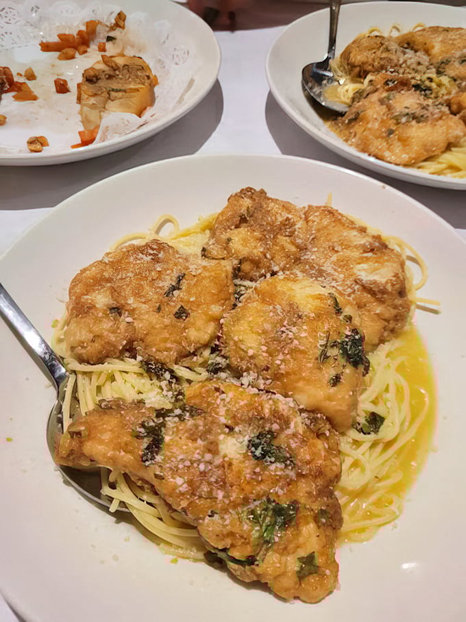 Golden chicken marsala lounging on a bed of pasta, basking in buttery sauce&mdash;like a sunbather who found the perfect spot on an Italian beach.