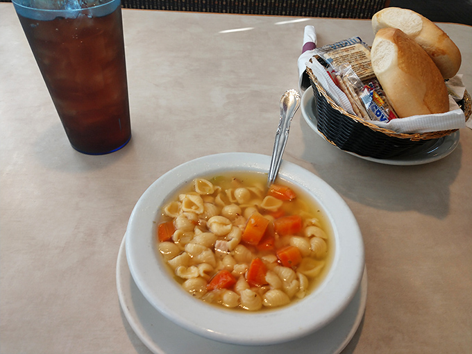 Chicken noodle soup that doesn't need a cold to justify its existence&mdash;clear broth, tender pasta, and a basket of bread standing by.