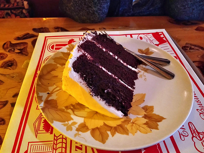 A slice of chocolate cake so rich and decadent it should come with its own warning label and possibly a thank-you note.