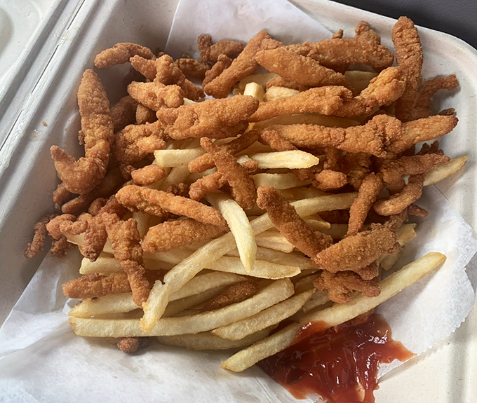 These aren't your cafeteria clam strips. Crispy, golden morsels of the sea arranged like a delicious game of pick-up sticks over fries.