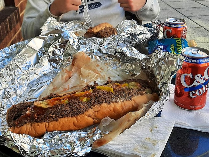 When your sandwich requires aluminum foil reinforcement and comes with its own security detail of soda cans, you know you're in for something special.