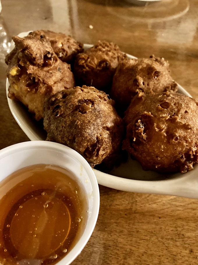 Corn fritters that could make a vegetable skeptic reconsider their life choices. Crispy outside, tender inside, with honey that seals the deal.