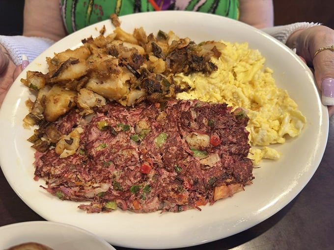 Corned beef hash with potatoes, eggs, and what appears to be a side of rice &ndash; a hearty plate that could fuel a morning of surfing or just serious newspaper reading.