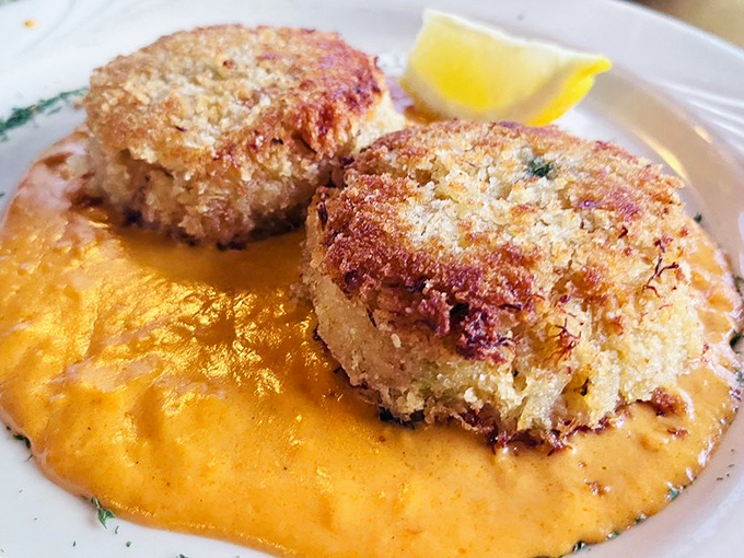 These crab cakes don't mess around&mdash;golden-crisp exteriors giving way to sweet, tender crab meat atop a sunset-colored sauce.