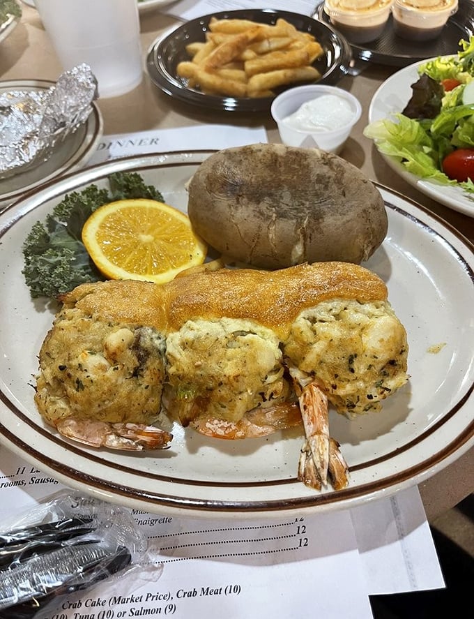 Stuffed shrimp that look like they've been working out, nestled beside a baked potato that's practically begging to be buttered.