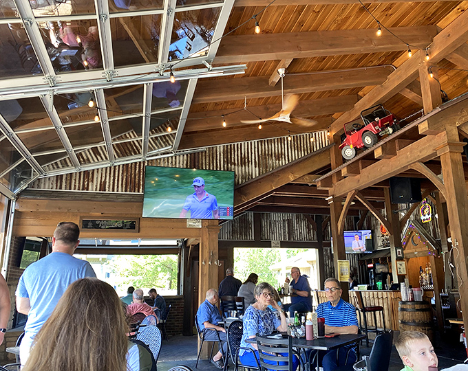 The soaring ceilings and natural light flooding through garage-style windows create an airy space for serious burger contemplation.