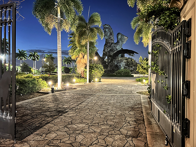 "Abandon all reality, ye who enter here"&mdash;the cave-like entrance beneath the statue adds a touch of adventure to your visit.
