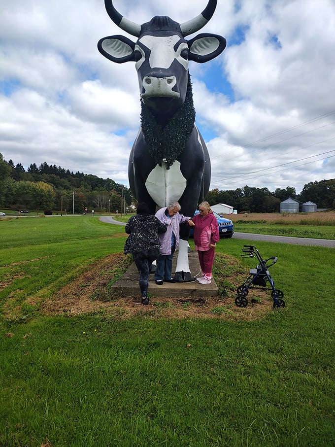 Three generations gather at the hooves of greatness, proving that the Big Cow brings families together better than most holiday dinners.