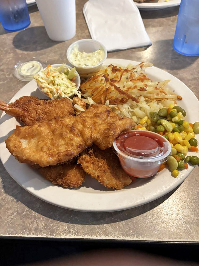 Golden-battered fish that would make Lake Erie proud, nestled alongside crispy fries and a rainbow of vegetables.