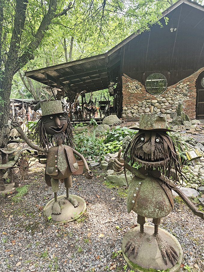 The welcoming committee at Jurustic Park features these charming metal folk with their stone hats and wire hair, standing ready to greet adventurous visitors.