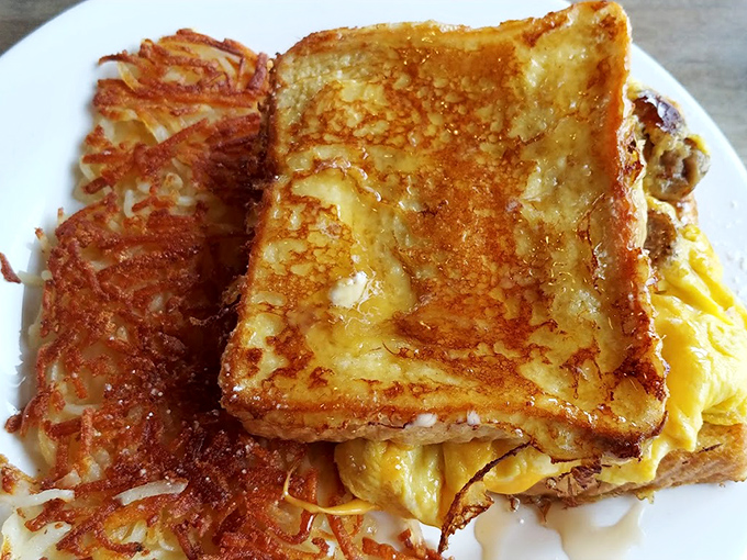 French toast that's had its passport stamped by the breakfast gods, lounging in a pool of syrup-y splendor.