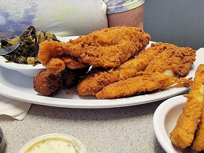 Golden-fried catfish that shatters with each bite, revealing flaky white flesh within&mdash;proof that simple food done right is culinary poetry.