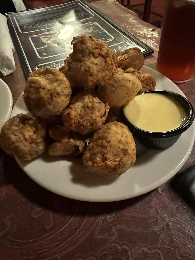 These aren't just fried mushrooms; they're little golden orbs of happiness with a dipping sauce that whispers, "Go ahead, have another."