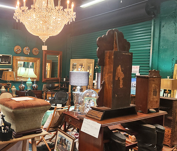 That chandelier could tell stories of grand dinner parties past, while the emerald walls create the perfect backdrop for furniture with character.