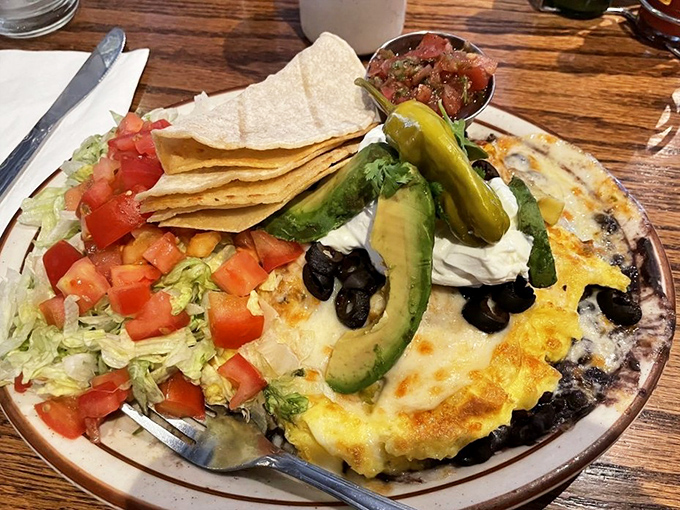 Huevos Rancheros that would make your abuela proud &ndash; a fiesta of flavors topped with fresh avocado and sour cream.
