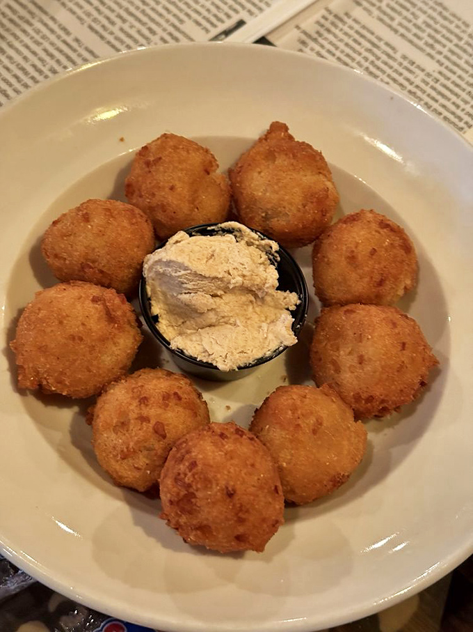 Hush puppies surrounding a creamy dip like golden sentinels guarding deliciousness. The perfect supporting act to any seafood star.