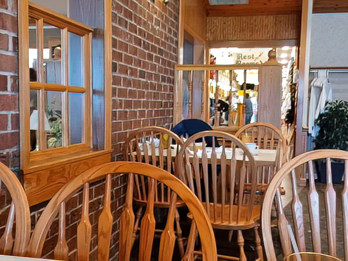 Wooden Windsor chairs and brick walls create that perfect "grandma's dining room" vibe. Comfort begins before the food even arrives.