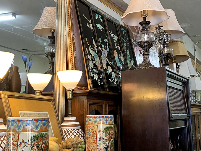 Elegant lamps and Asian-inspired screens create a corner that feels like you've stumbled into a movie set designer's private collection.