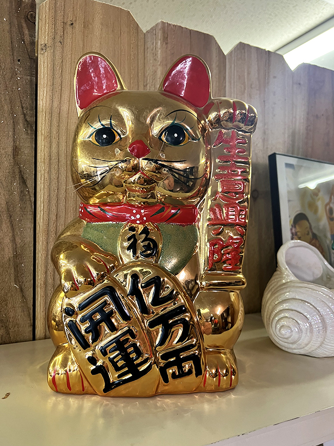 This lucky cat isn't just waving—he's beckoning you toward good fortune and excellent vintage finds. Wave back, just in case.